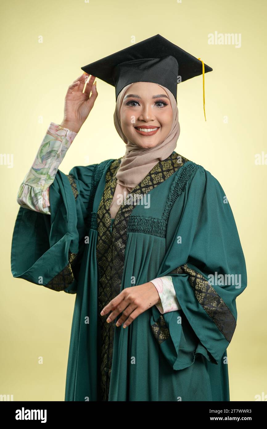 Female muslim lady posing in graduation attire Stock Photo - Alamy