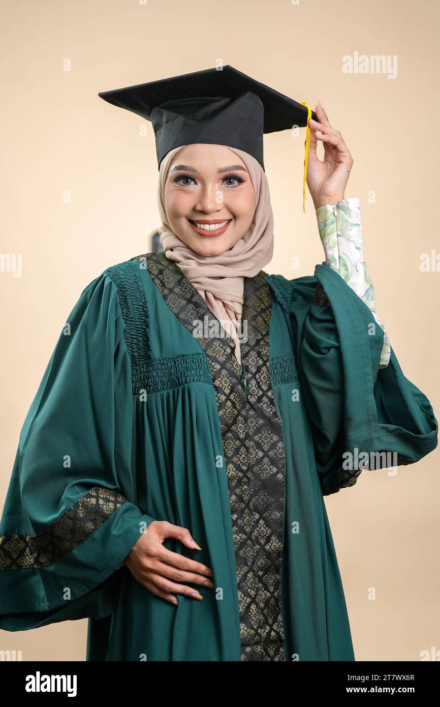 Female muslim lady posing in graduation attire Stock Photo - Alamy