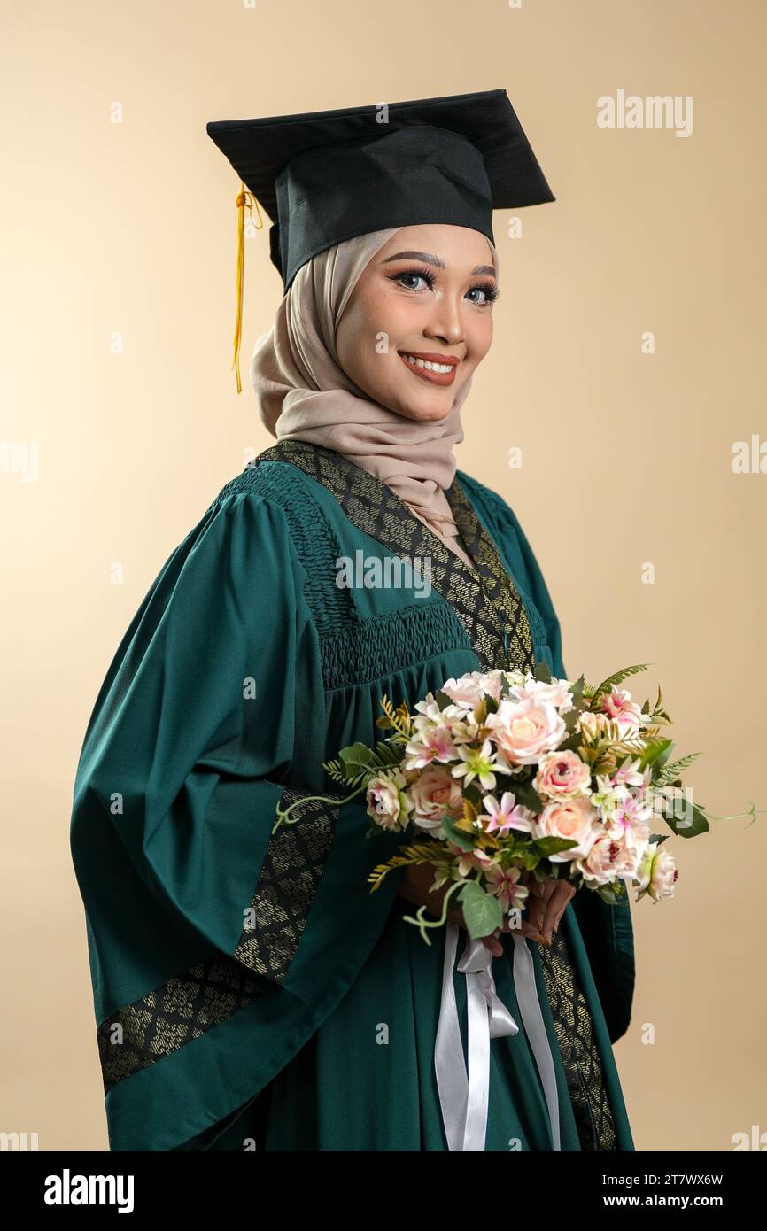 Female muslim lady posing in graduation attire Stock Photo - Alamy