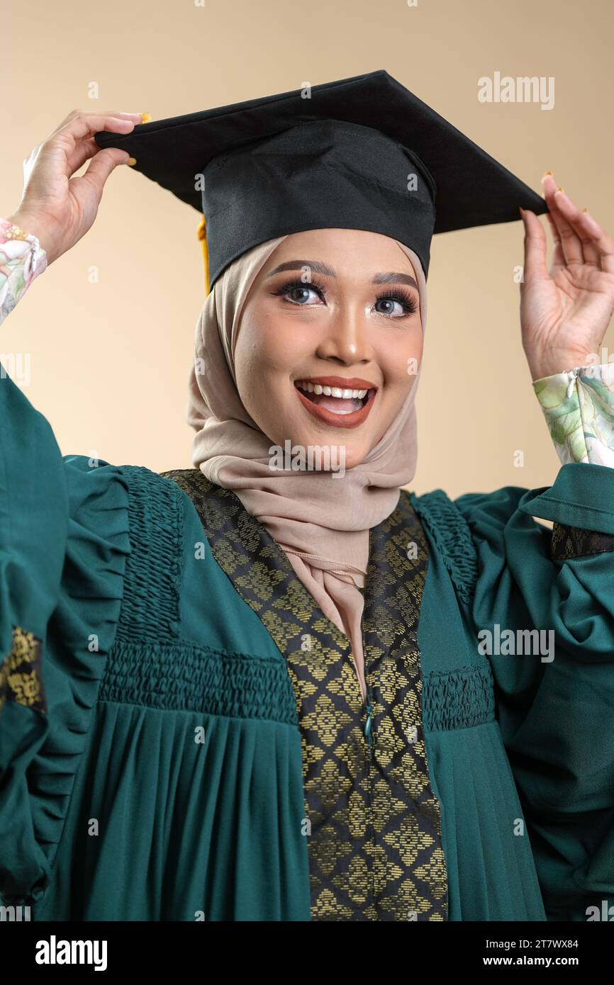 Female muslim lady posing in graduation attire Stock Photo - Alamy