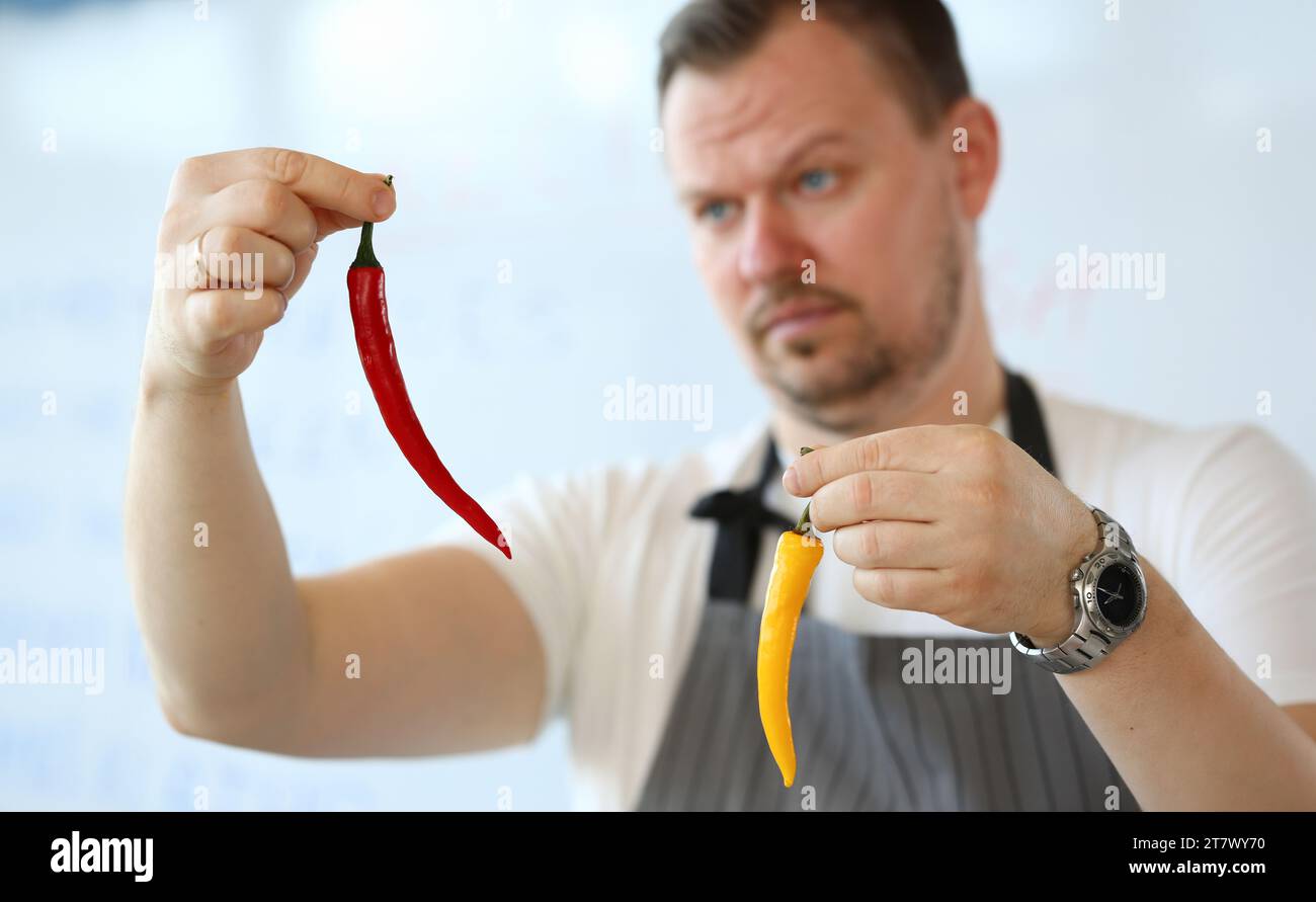 Professional Chef Showing Yellow Chili Pepper Stock Photo - Alamy