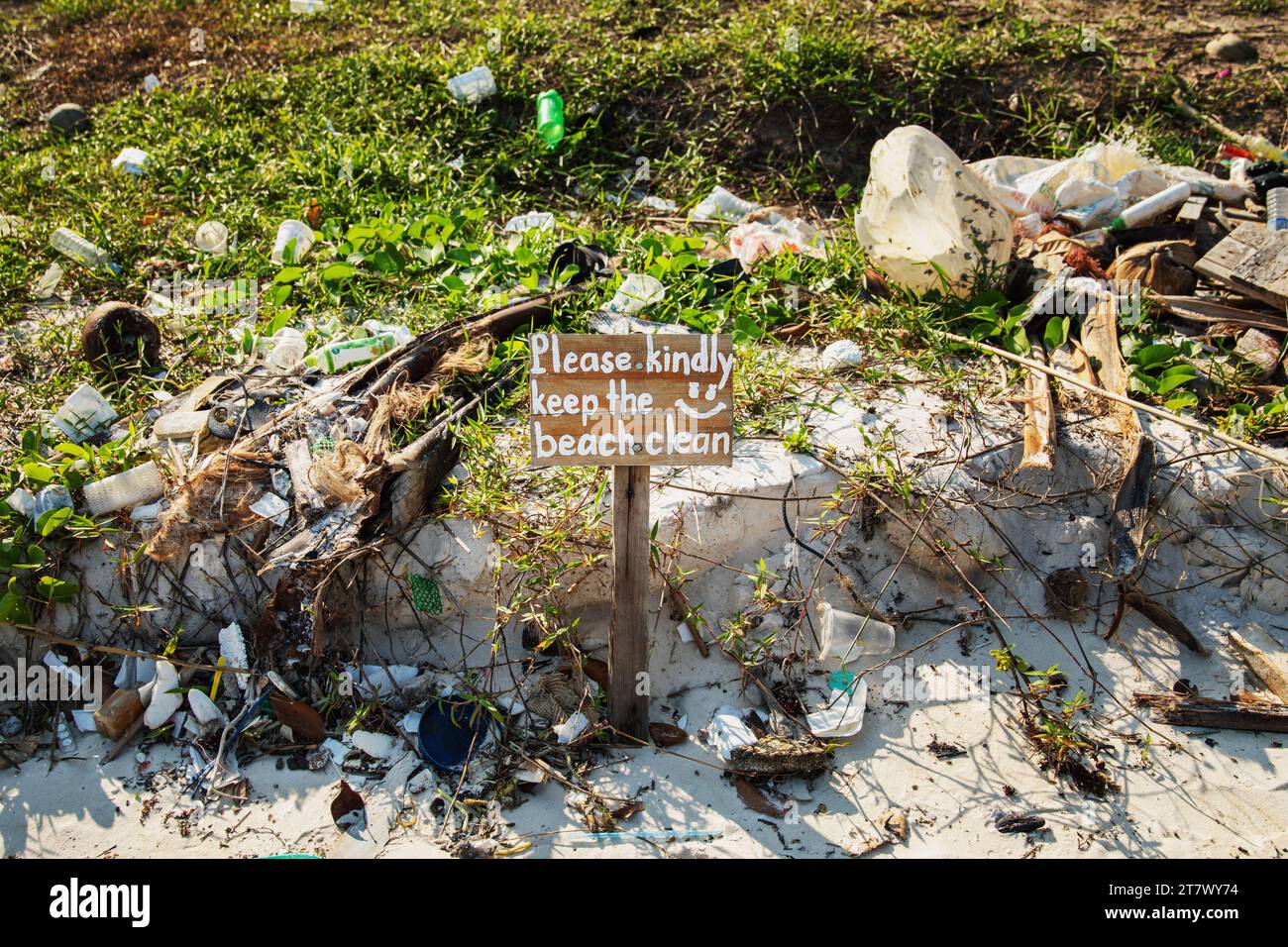 Sign saying "'Please kindly keep the beach clean"" and pile of ...