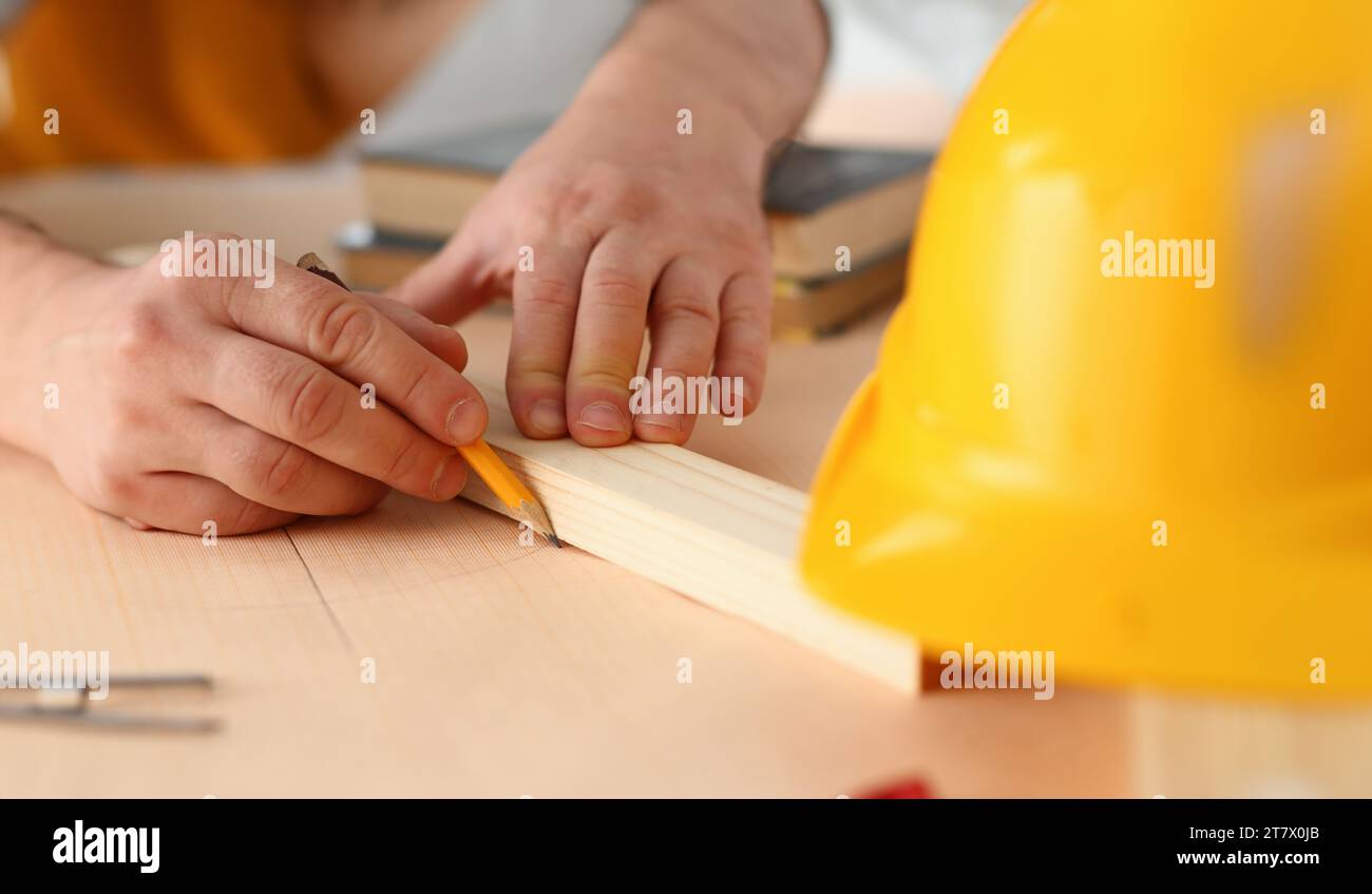 Arms of worker making structure plan Stock Photo - Alamy