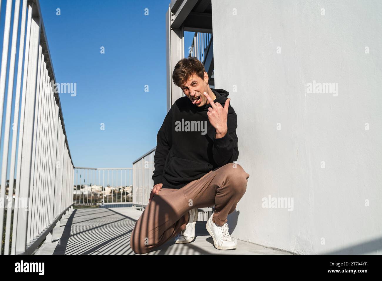Aggressive man showing middle finger as offensive gesture Stock Photo ...