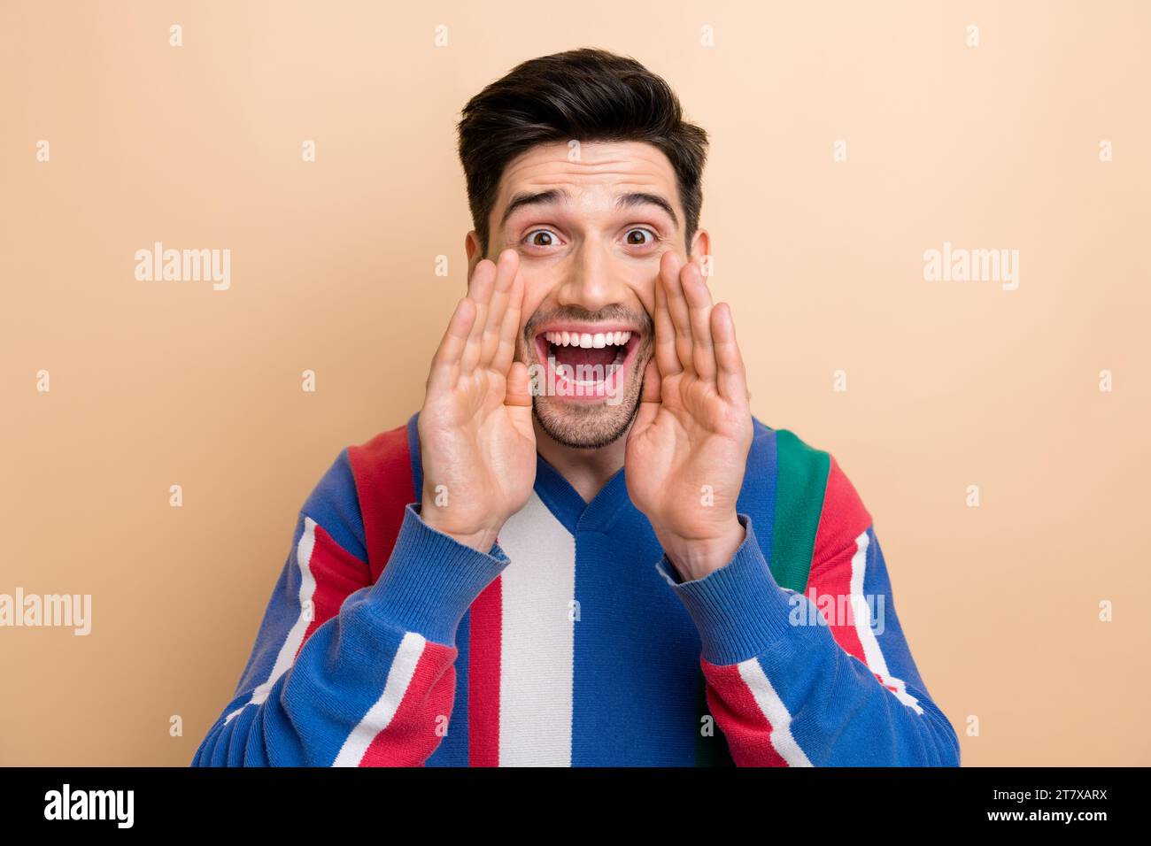 Close up photo of young handsome guy screaming loud voice hands palms ...