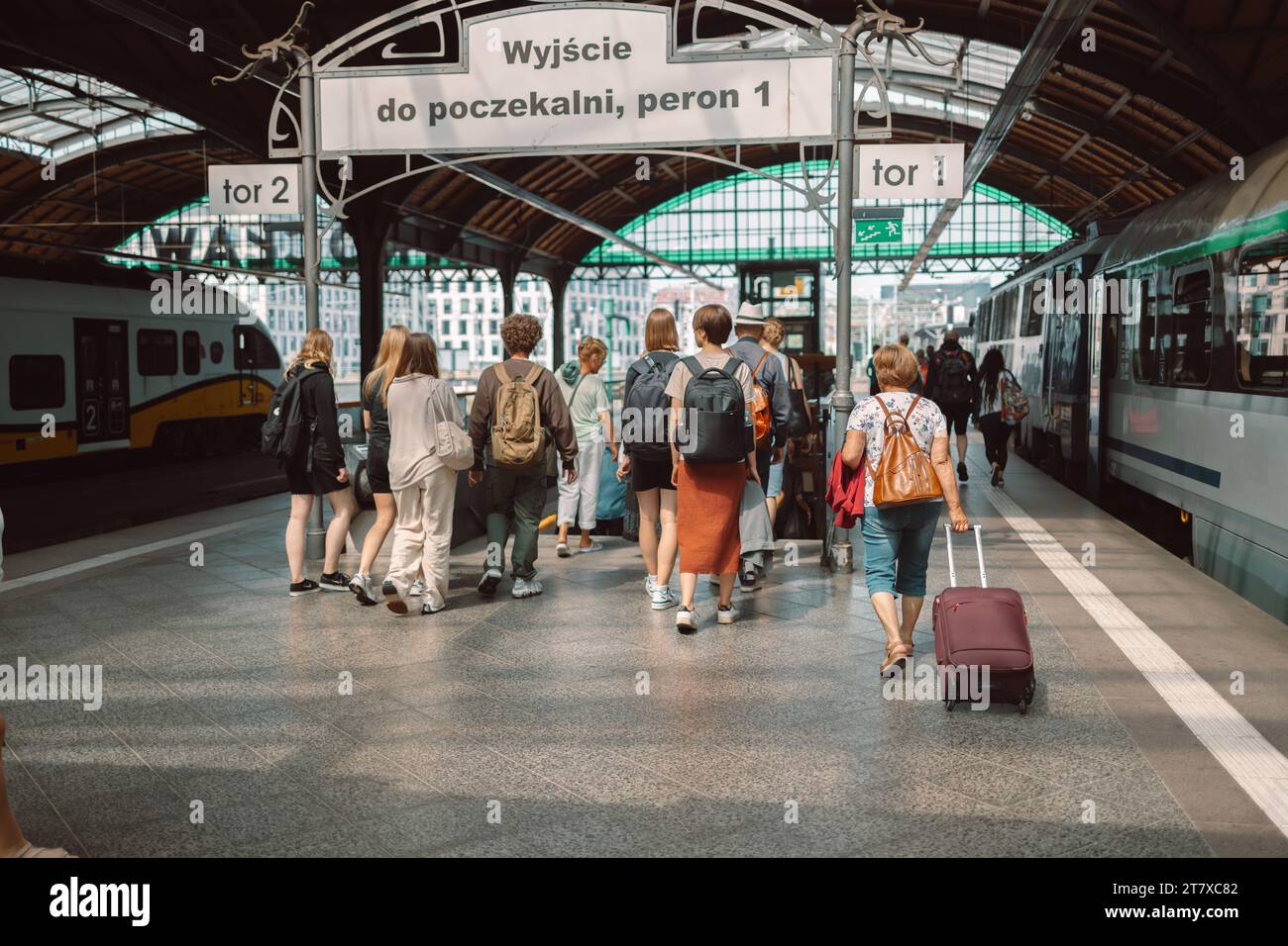 Large group of people go down into the underground passage on a ...