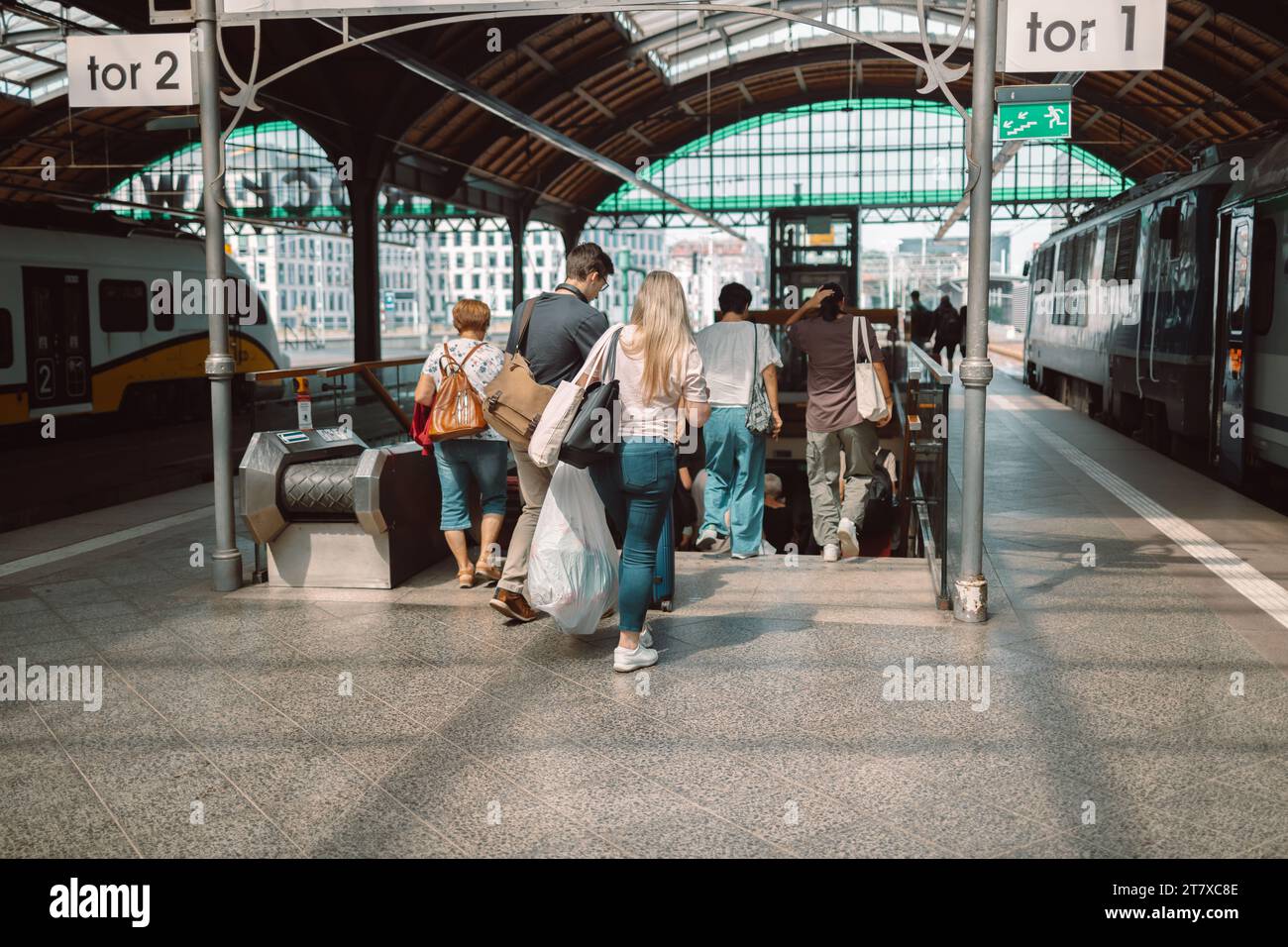 Large group of people go down into the underground passage on a ...