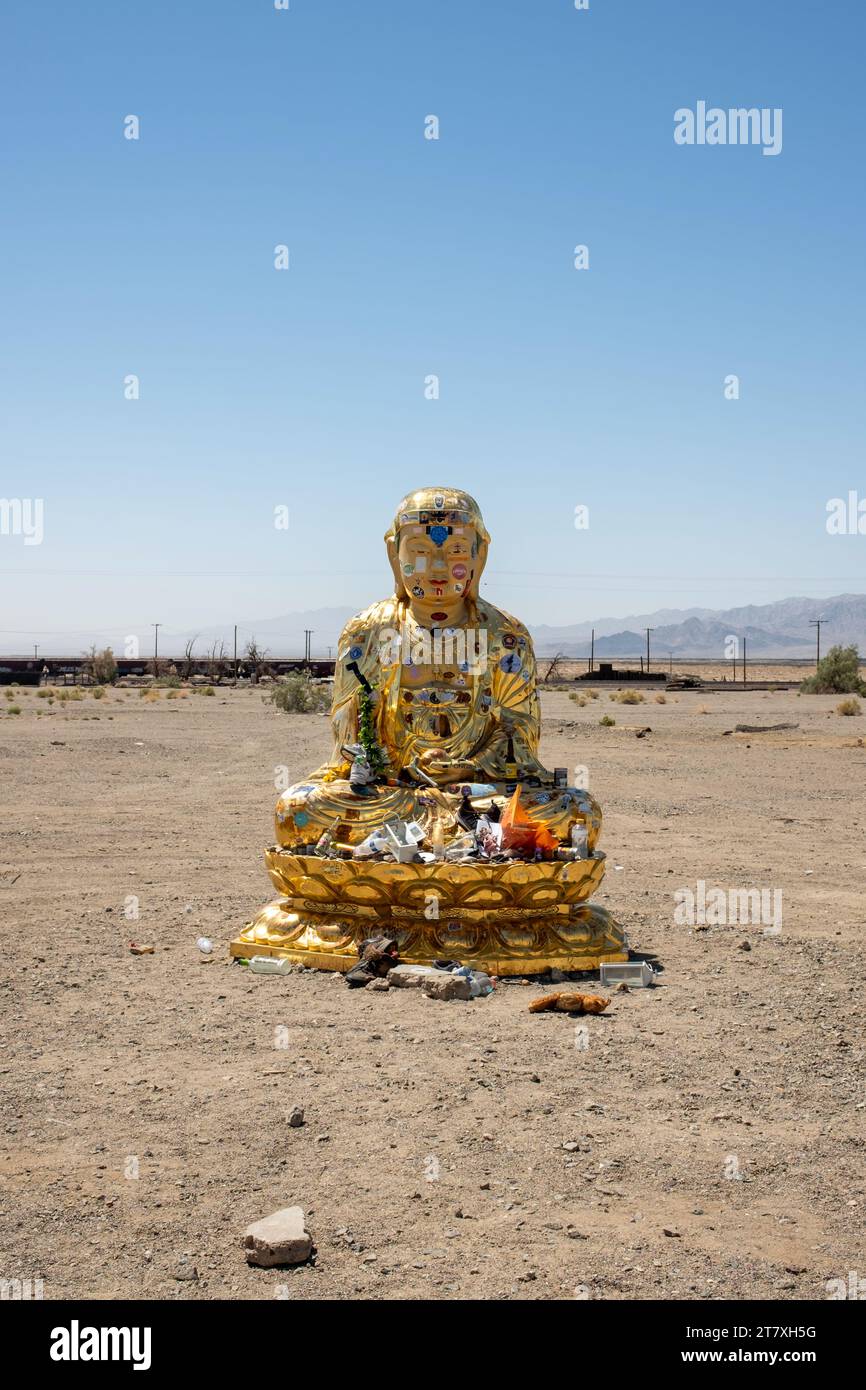 Mojave Desert, California - May, 14, 2023: A golden statue of Buddha ...