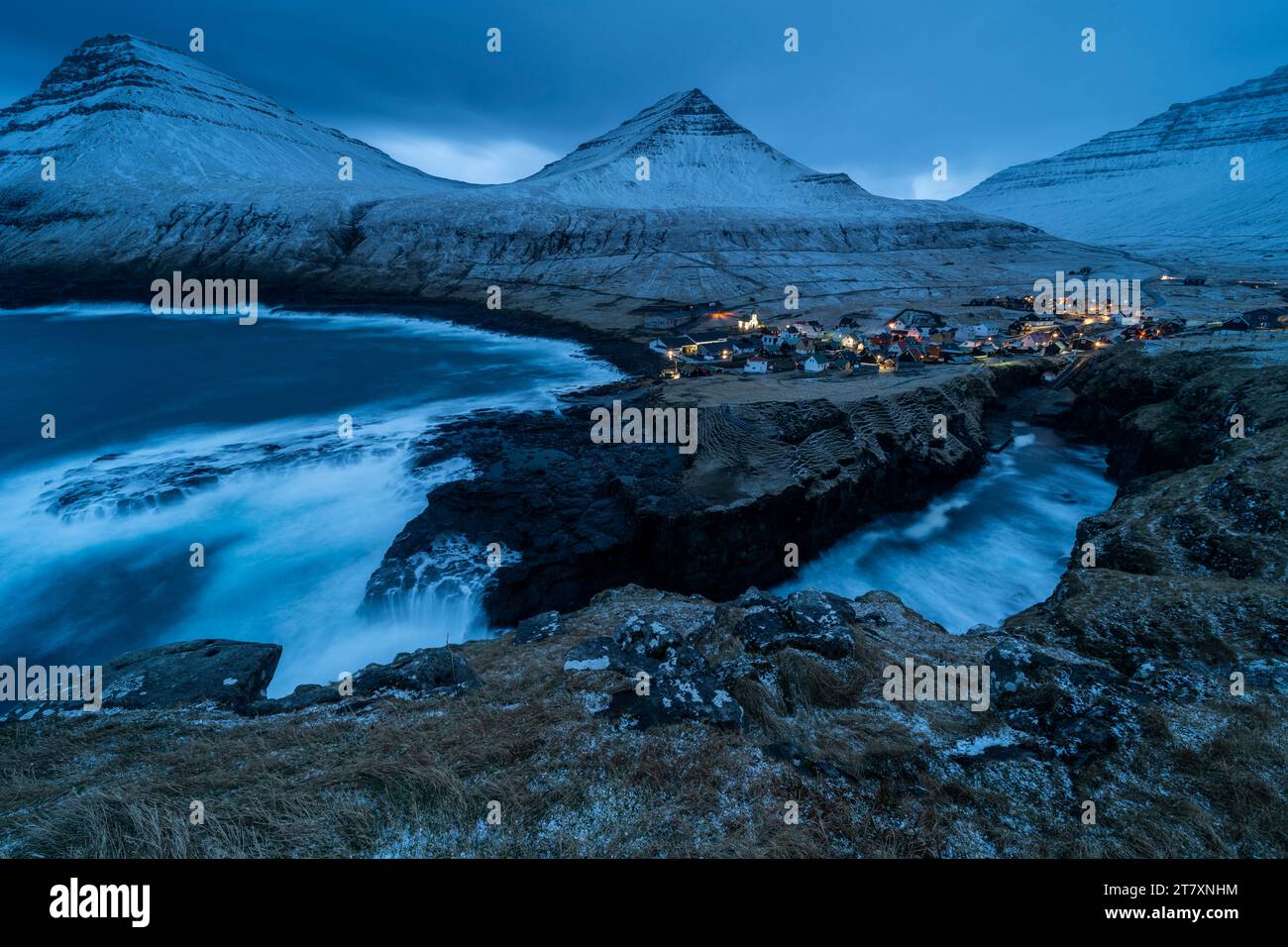 Gjogv village and snow covered mountains at dusk, Gjogv, Eysturoy ...