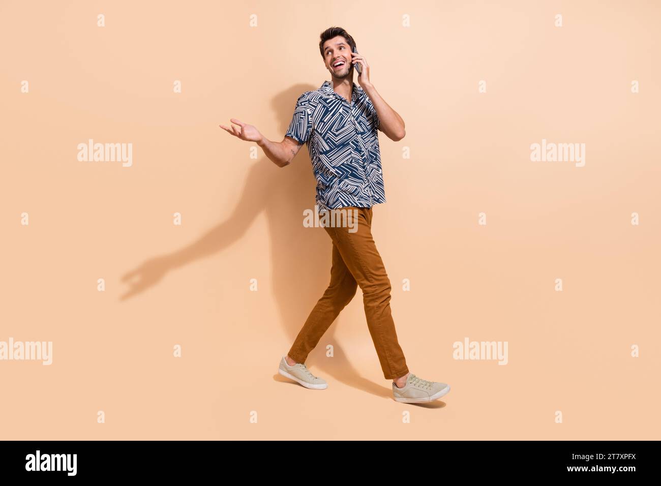 Full length photo of young man talking people making a phone call looks ...