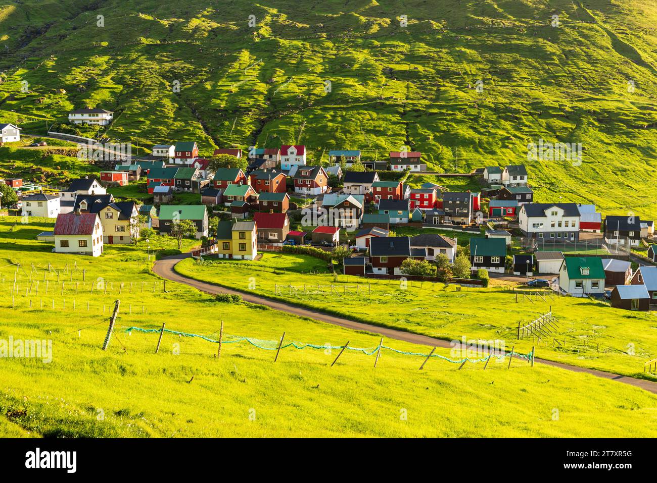 The colorful houses of the fishing village of Funningur at sunrise ...