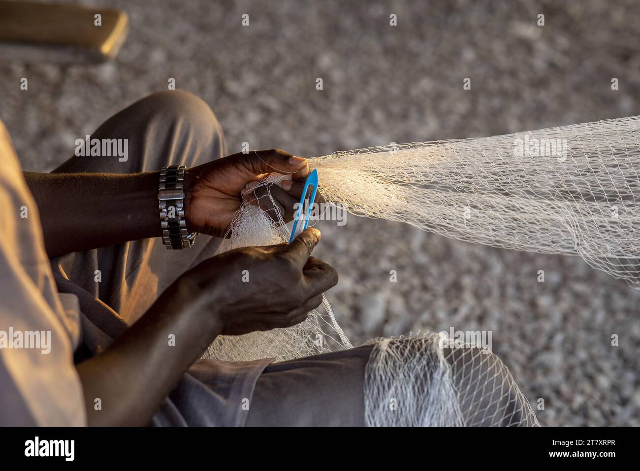 Fisherman mending nets in Fadiouth, Senegal, West Africa, Africa Stock ...