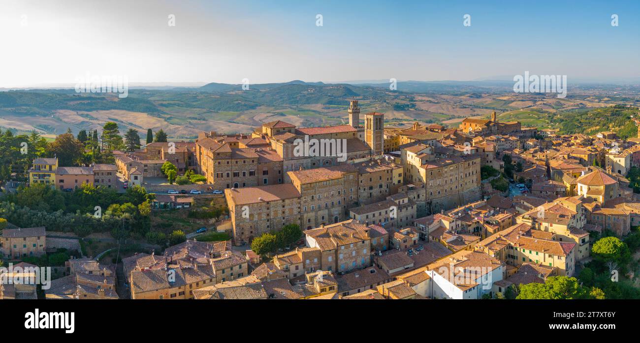 Elevated view of rooftops and town of Montepulciano at sunset ...