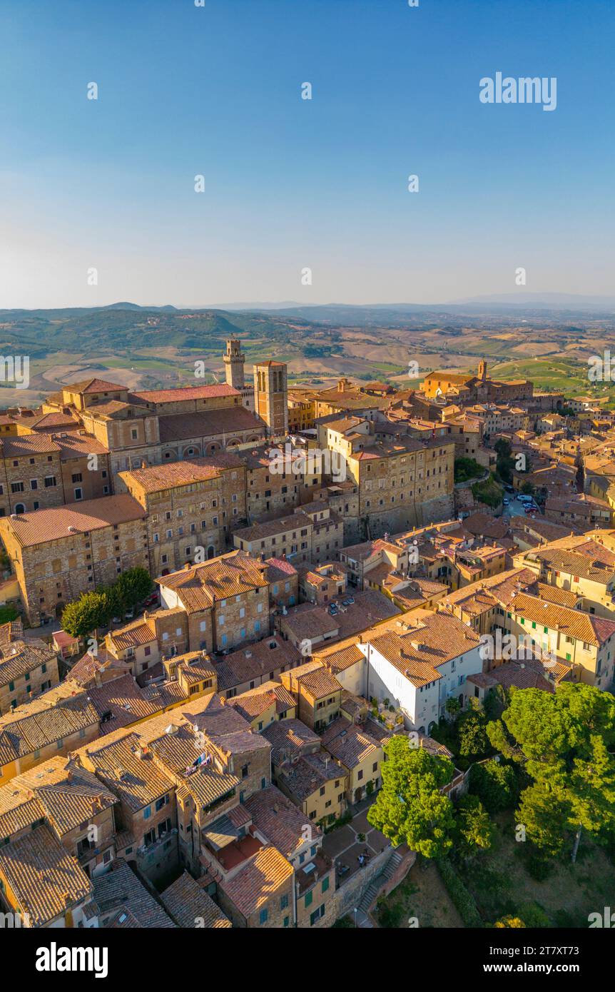 Elevated view of rooftops and town of Montepulciano at sunset ...