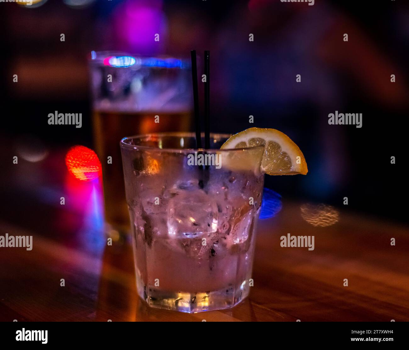 Half Gone Pink Cocktail Drink at Bar Pub Restaurant with Lemon Stock ...