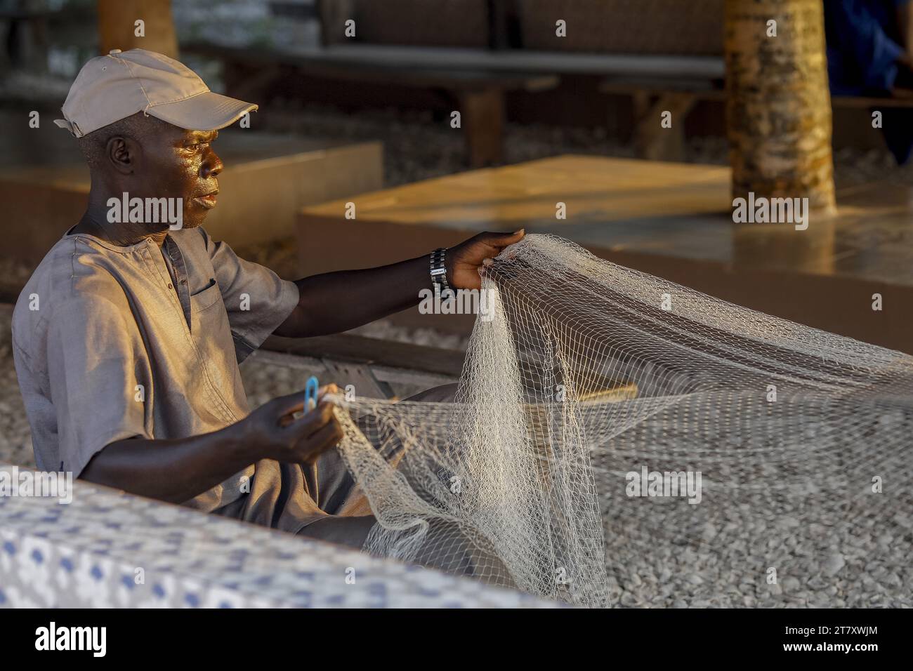 Fisherman mending nets in Fadiouth, Senegal, West Africa, Africa Stock ...