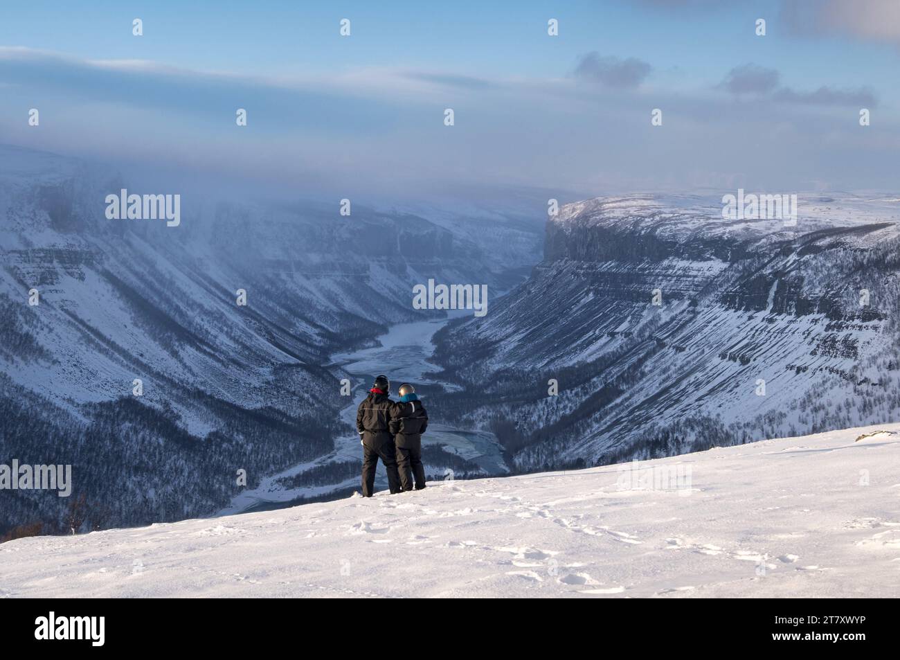 Couple in Snowsuits looking out over the Alta Canyon and Alta River ...