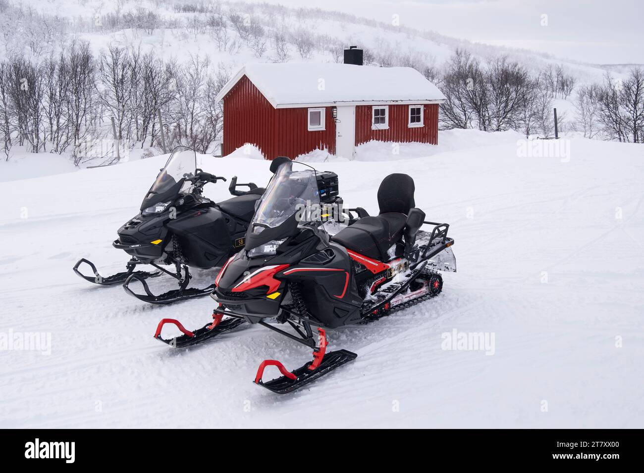 Snowmobiles outside a traditional Sami Cabin (Hytte) in winter, near ...