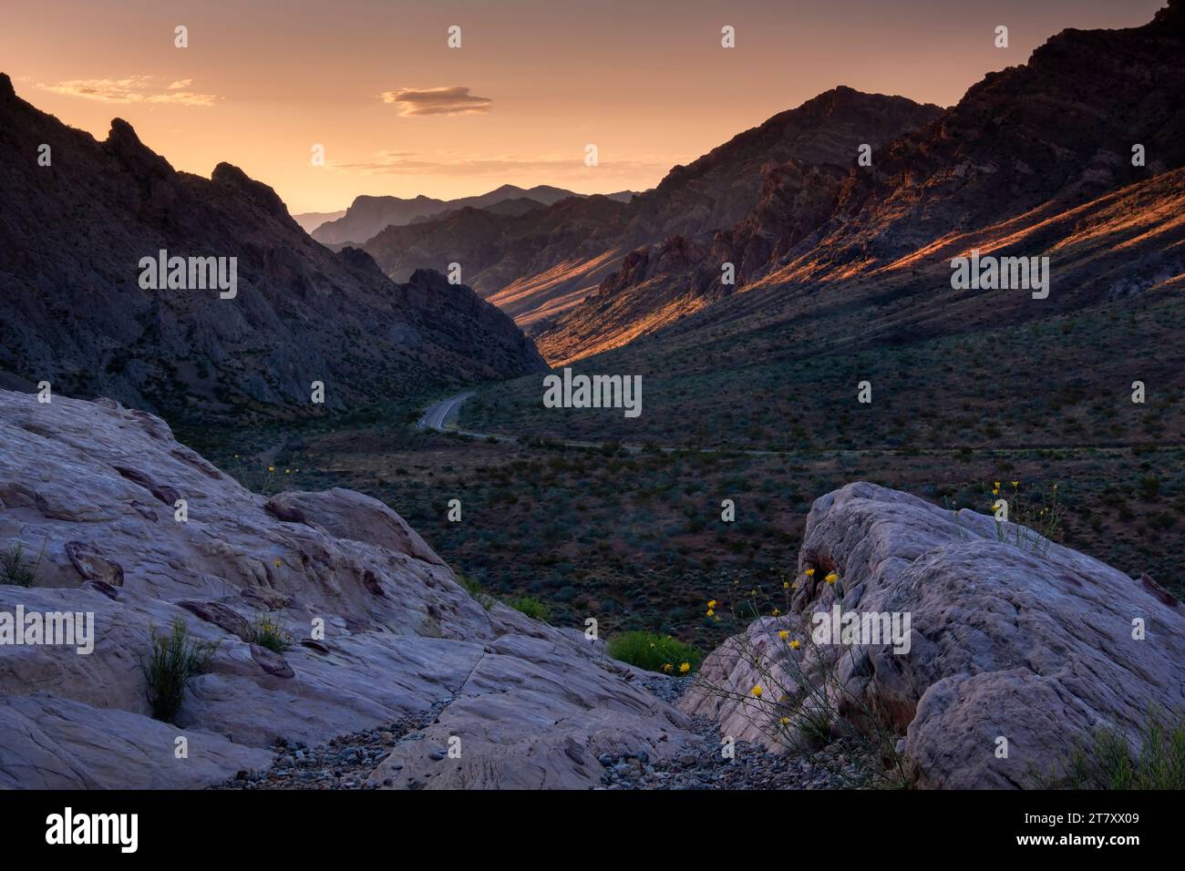 Sunrise illuminates the pass through the mountains at the western ...