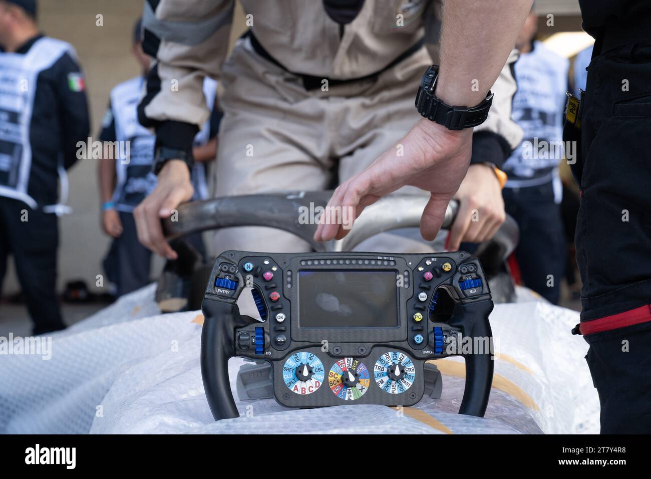 A stand-in driver climbs into a F1 car as part of the extrication team ...