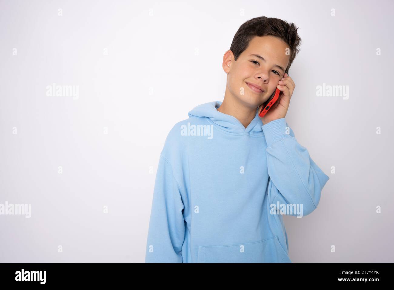 Happy boy using smartphone. Handsome teenage boy holding mobile phone ...