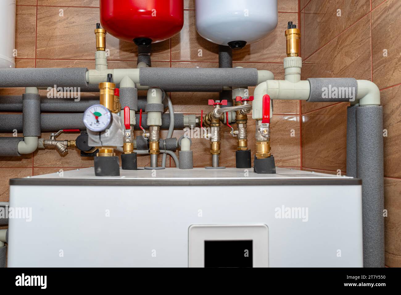 A modern air heat pump installed in the home's boiler room, visible ...