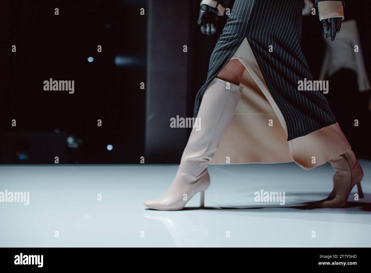 Black long skirt and beige high heels. Fashion model walking runway ...