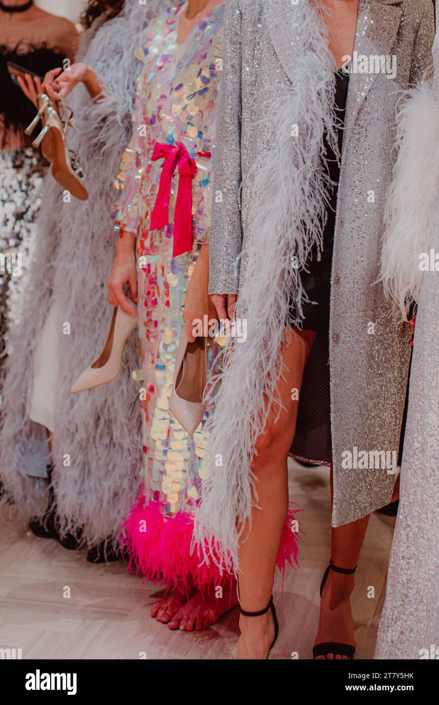 Silhouettes of fashion models on backstage dressed in a long Haute ...