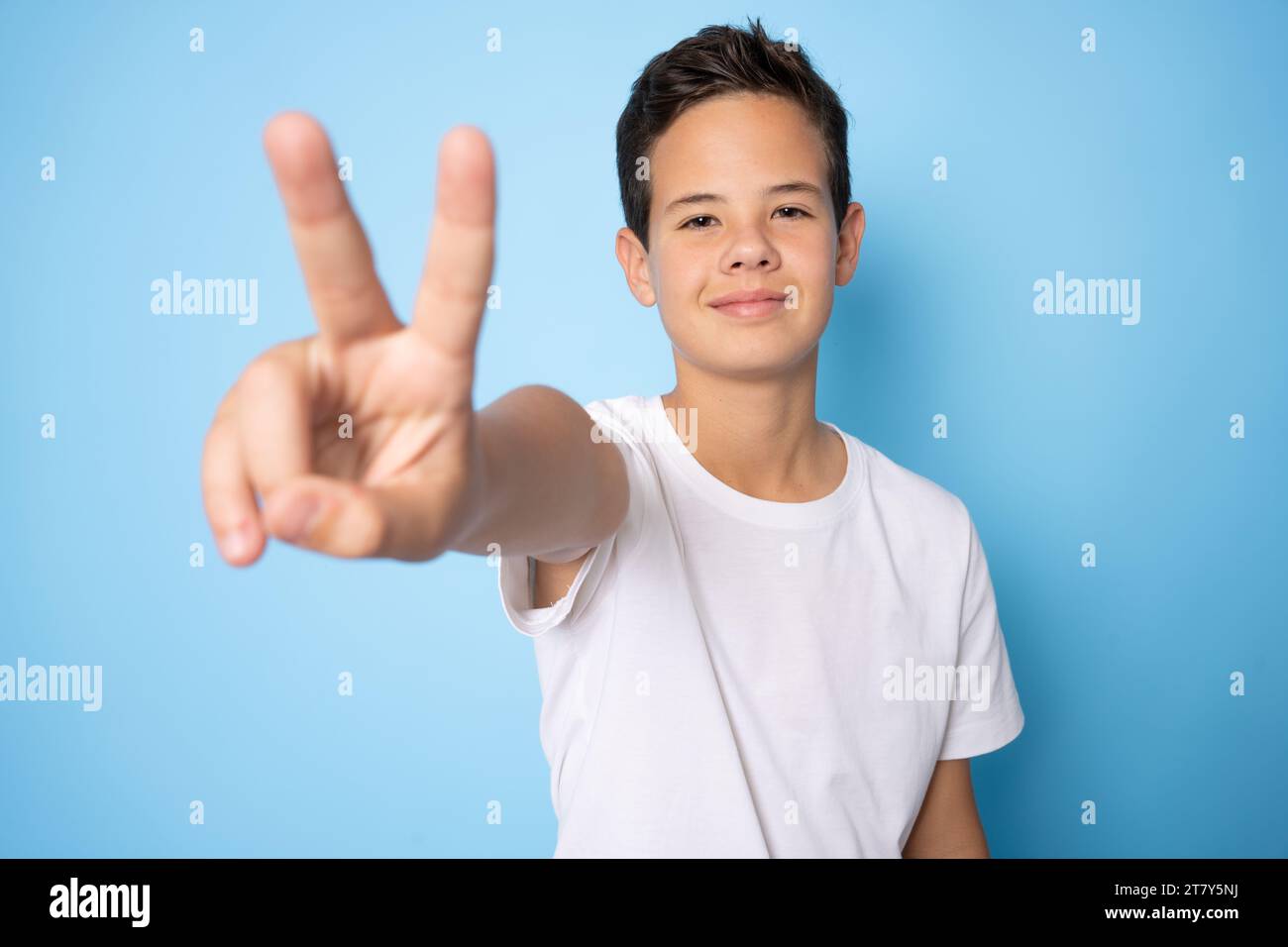 Caucasian teen boy Doing peace symbol with fingers over face, smiling ...