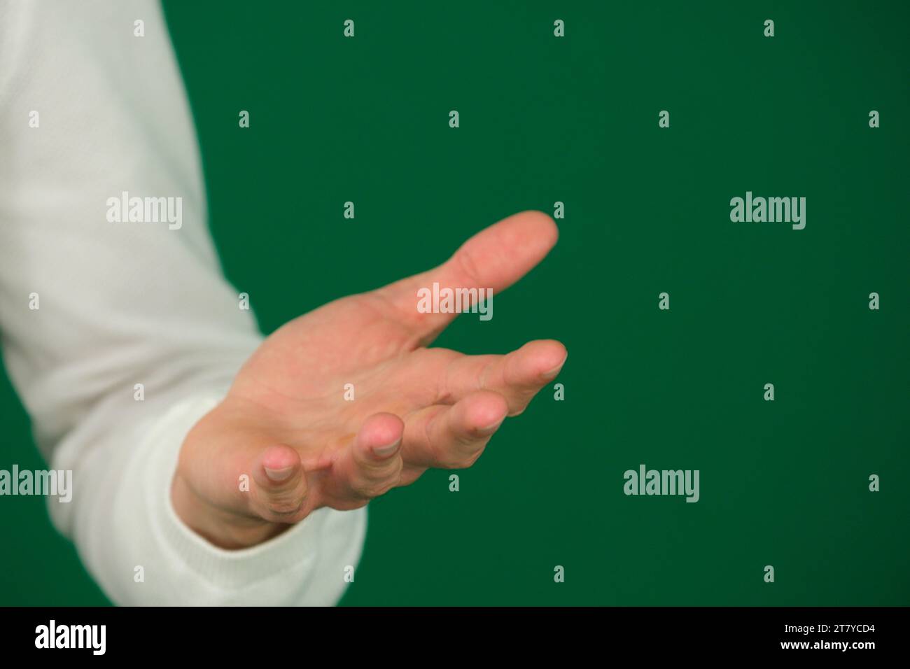 Empty hand palm up gesture, isolated man guy on a green background ...