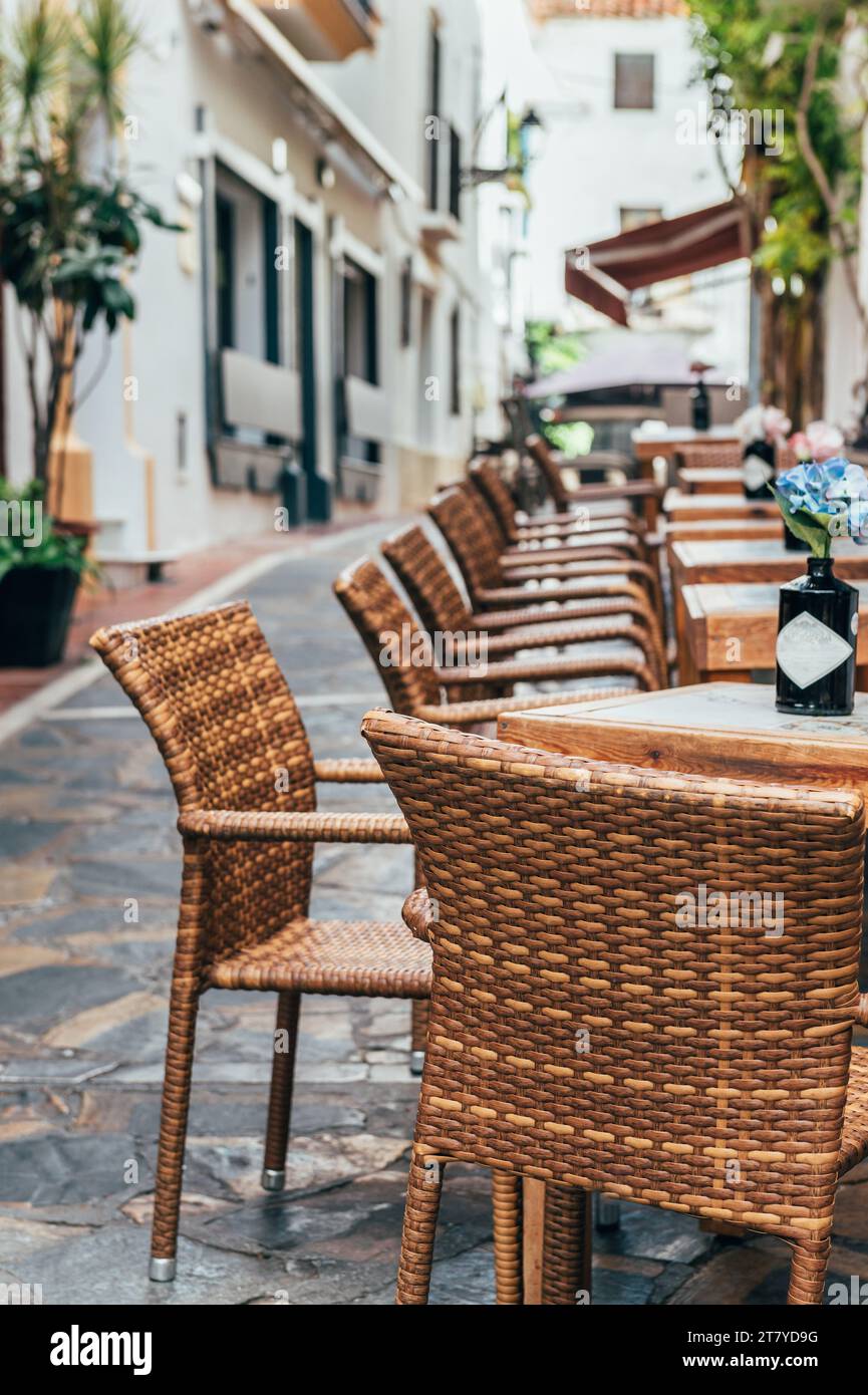 Cafe tables on Streets of Marbella, Spain Stock Photo - Alamy