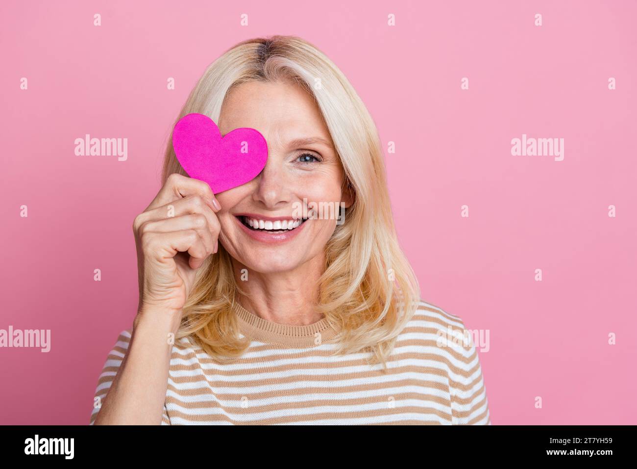 Portrait of friendly aged person toothy smile hand hold small heart ...
