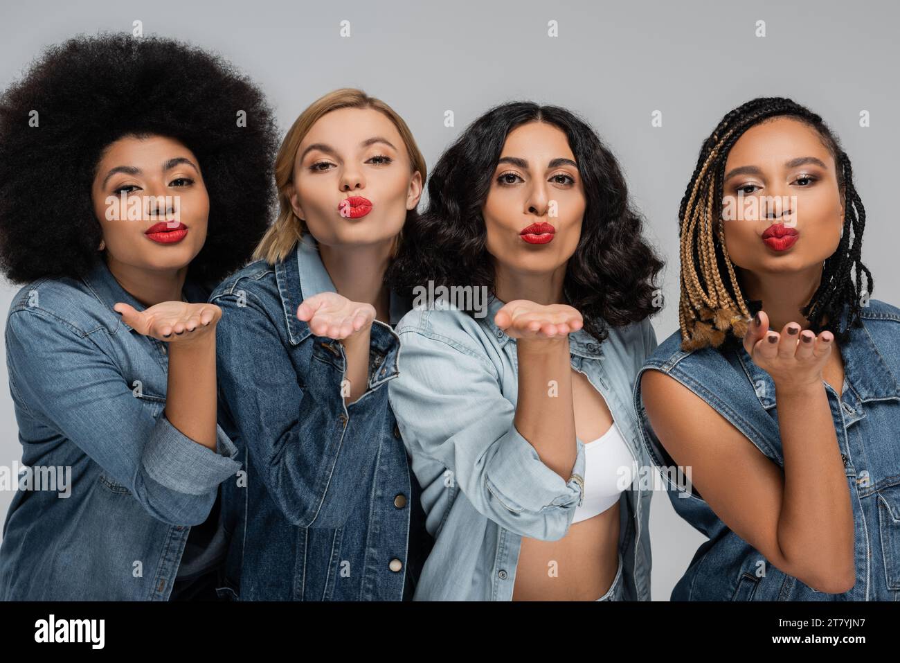 alluring multiracial girlfriends blue denim outfits blowing air kisses ...