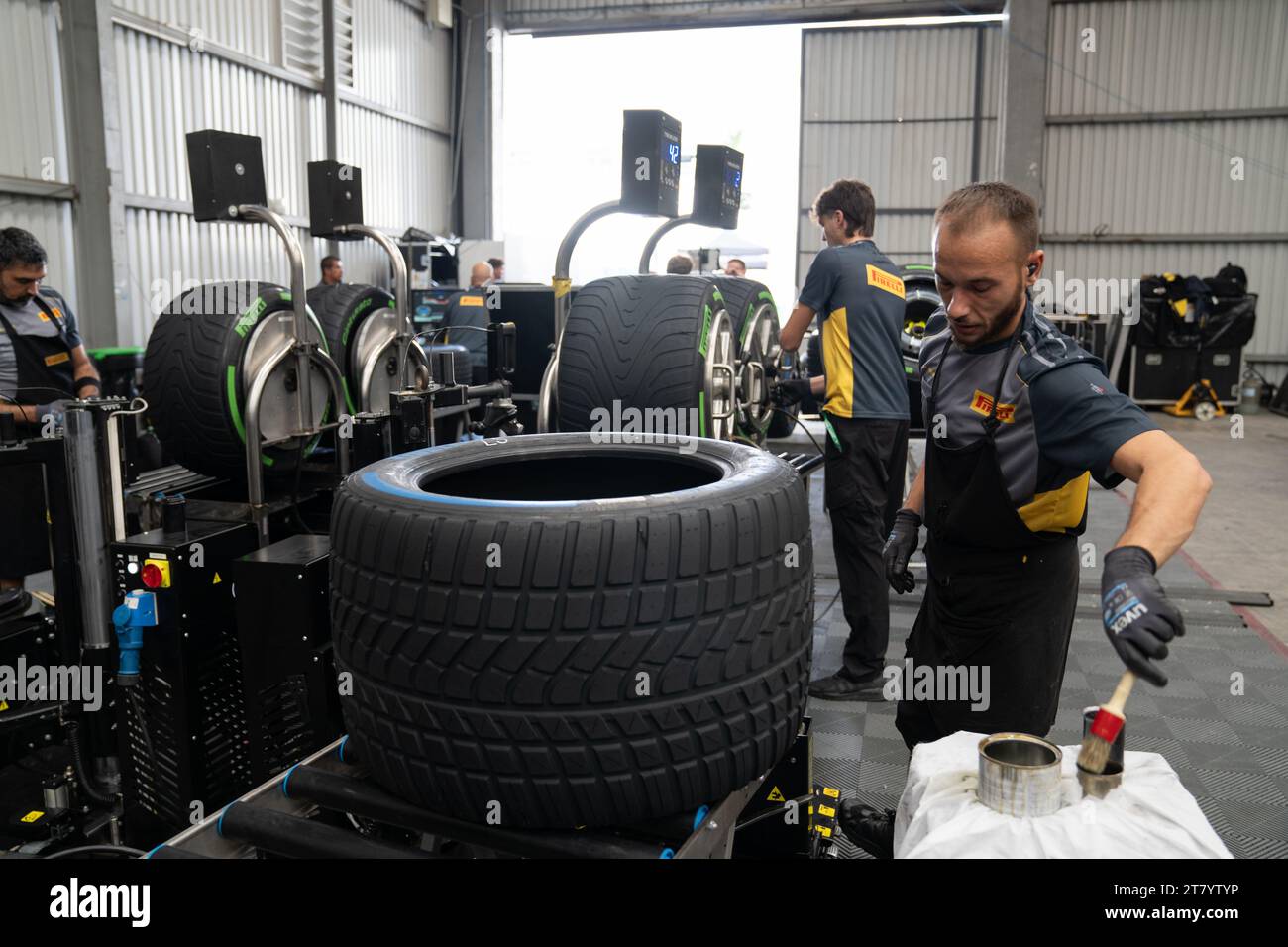 Pirelli’s fitters use glue to attach the tyre to the team's wheel ...