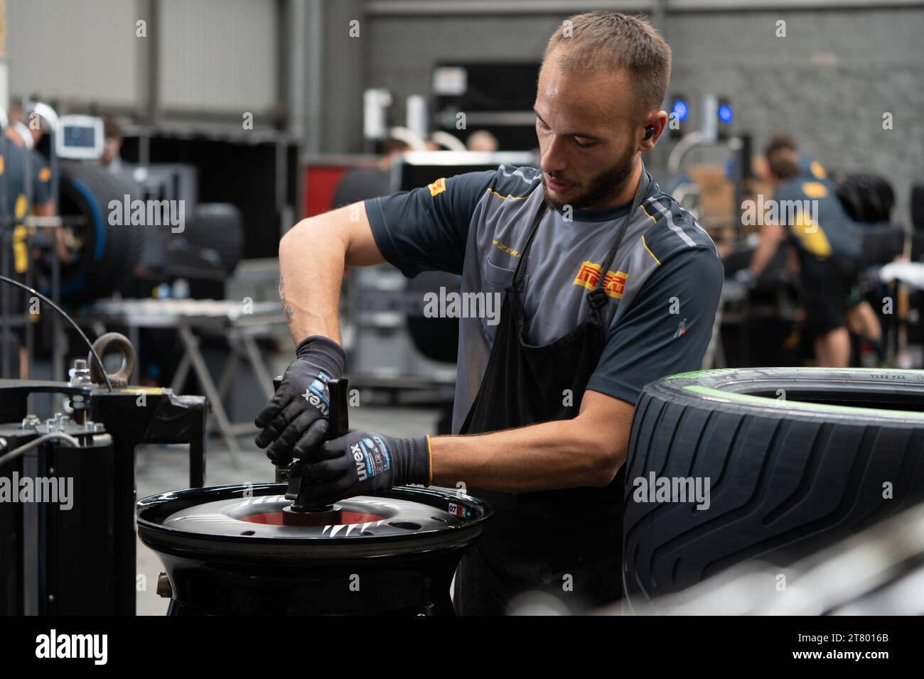 Pirelli’s fitters attach the wheels to the designated tyres for each ...