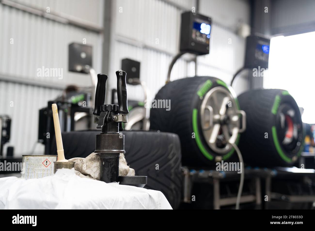 Pirelli’s fitters use glue to attach the tyre to the team's wheel ...