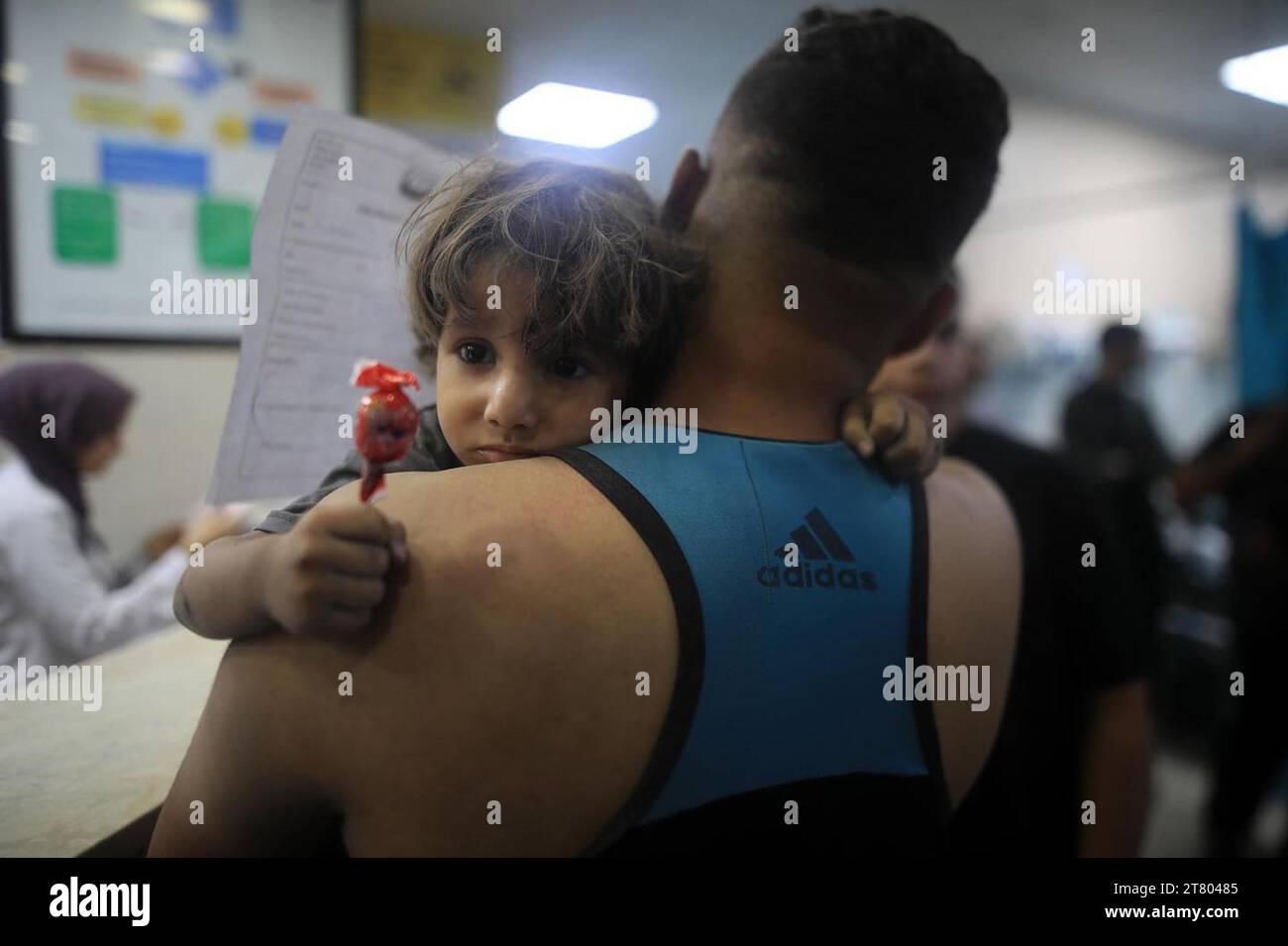 A Palestinian father hugs his daughter at a hospital after his house ...