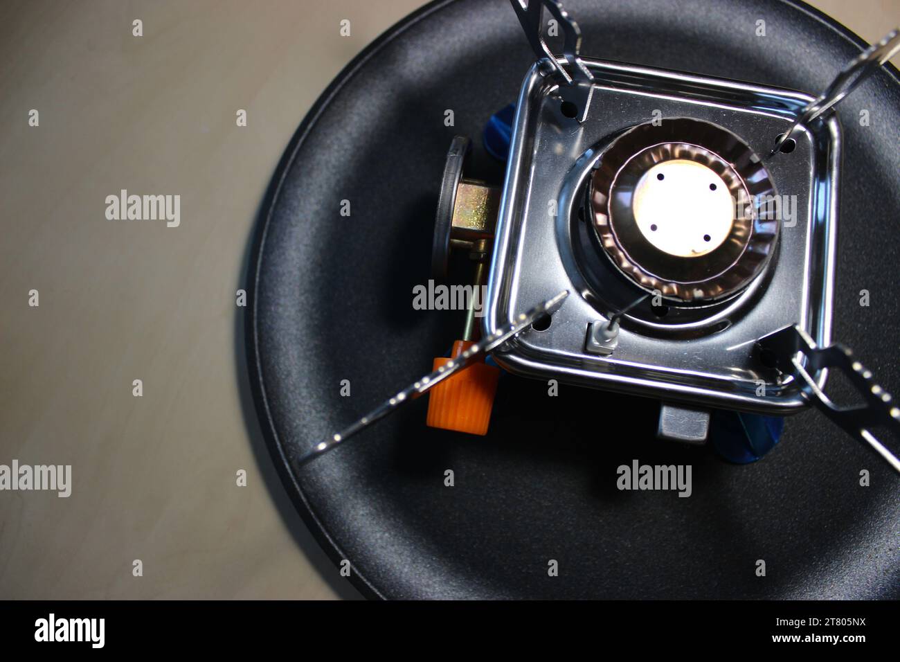 Folding Ultralight Camping Stove On A Ceramic Surface Of Thin Pan ...