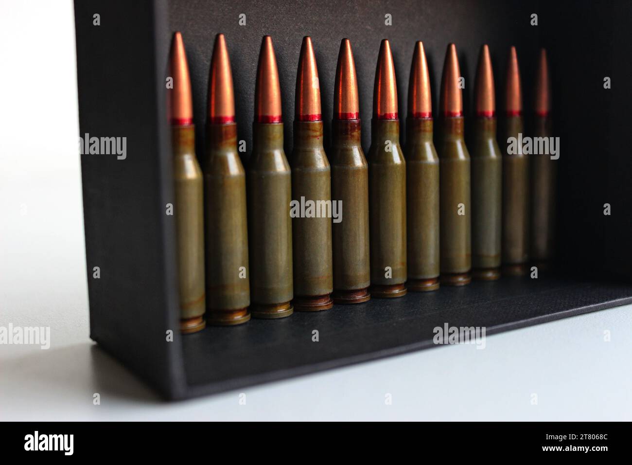 An even row of machine gun bullets lined up in black box Stock Photo ...