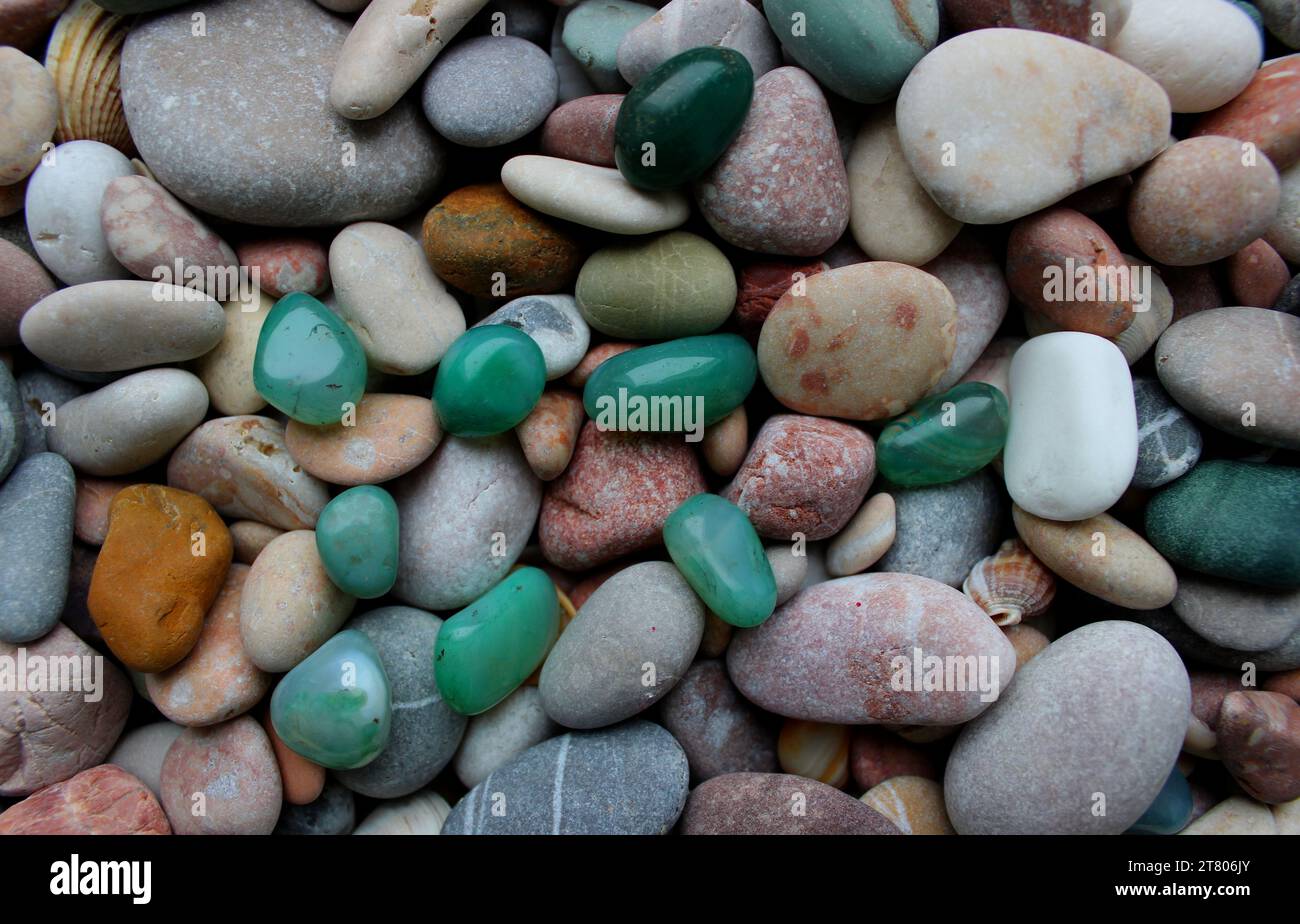 Green Semi-Precious Stones On A Colored Pebbles With Quartz Veins ...