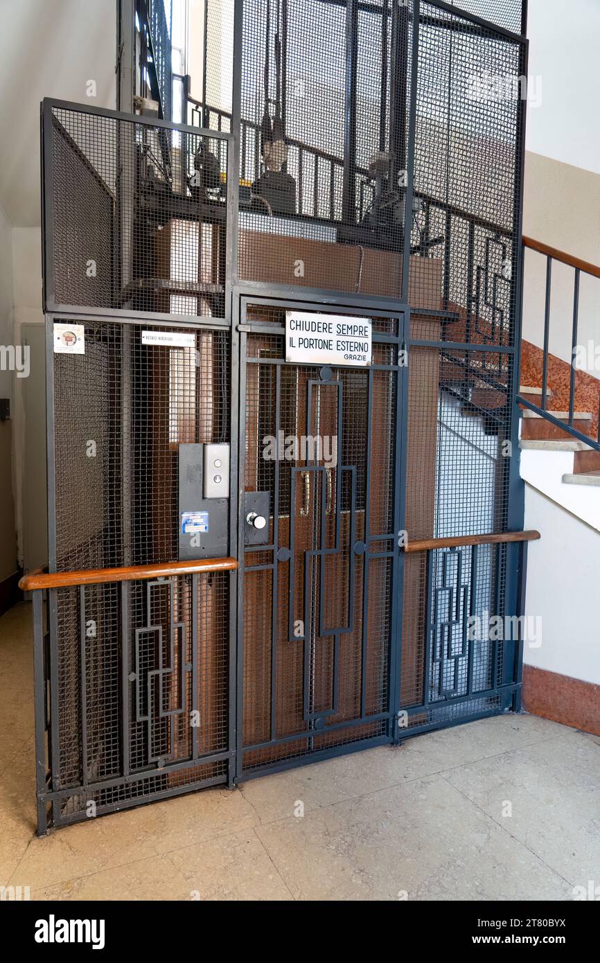 an old Italian wooden elevator with metal gates Stock Photo - Alamy