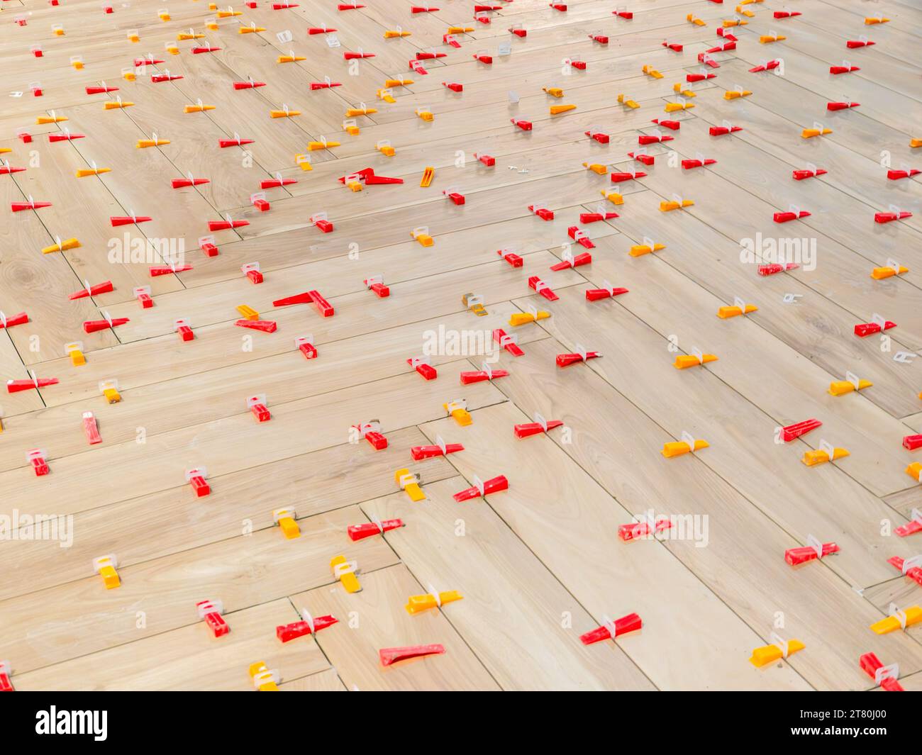 Piece of leveling and spacing plugs on tile floor installation stage ...