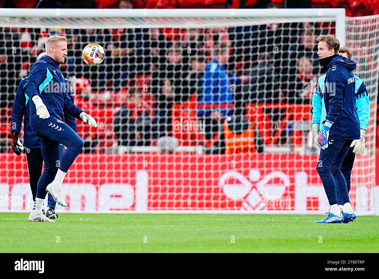 Danish goalkeeper Kasper Schmeichel (L) and Frederik Ronnow warms up ...