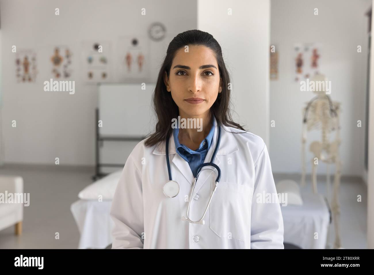 Serious medical intern girl posing in clinic educational boardroom ...