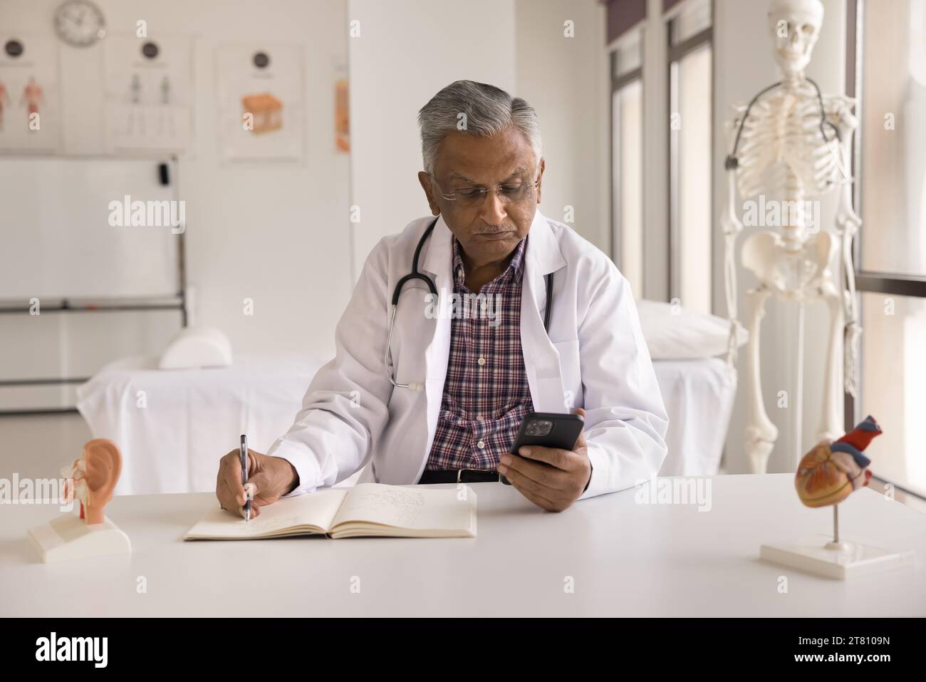 Serious elder Indian doctor man giving medical consultation on Internet ...