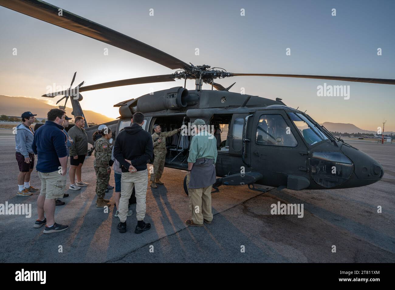 Visiting VIP's get a close-up look at a US ARMY Blackhawk helicopter that is about to fly them ...