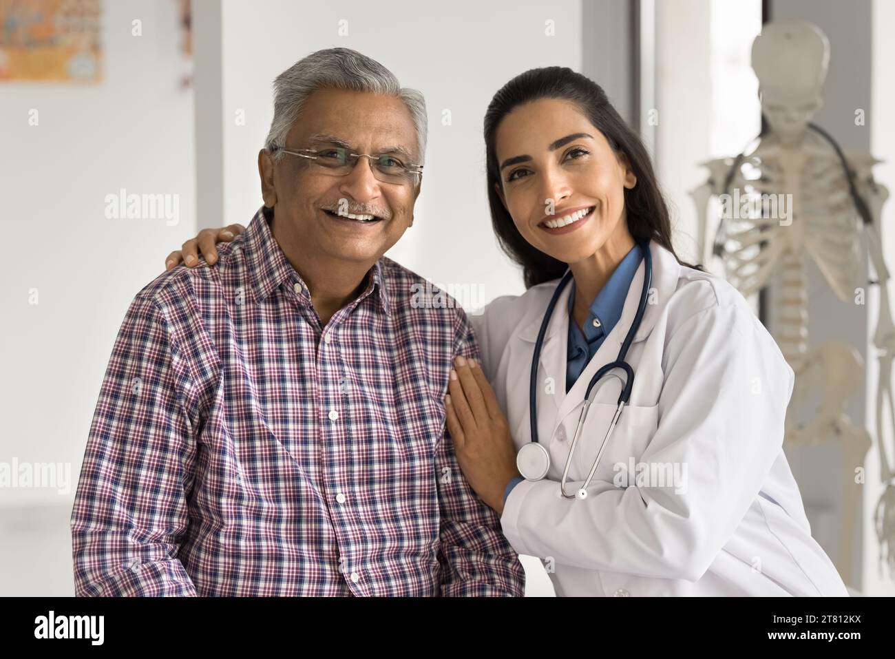 Positive beautiful young medical professional woman embracing elderly ...