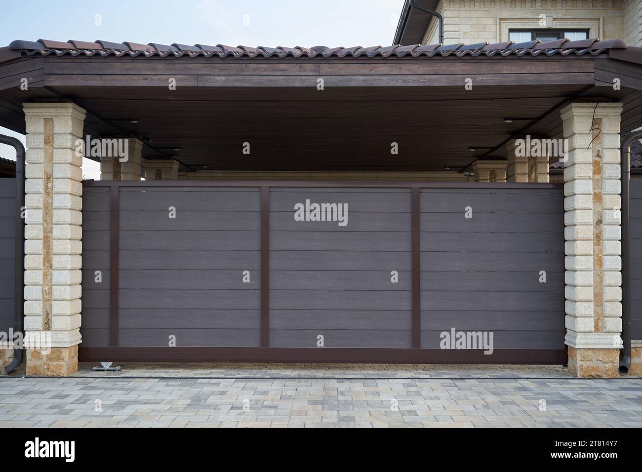 Modern side sliding gates with canopy Stock Photo - Alamy