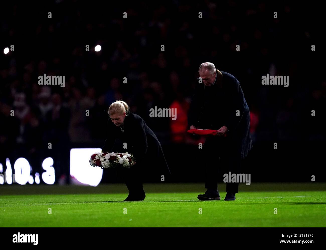 Sir Geoff Hurst lays Sir Bobby Charlton's shirt on the centre circle ...