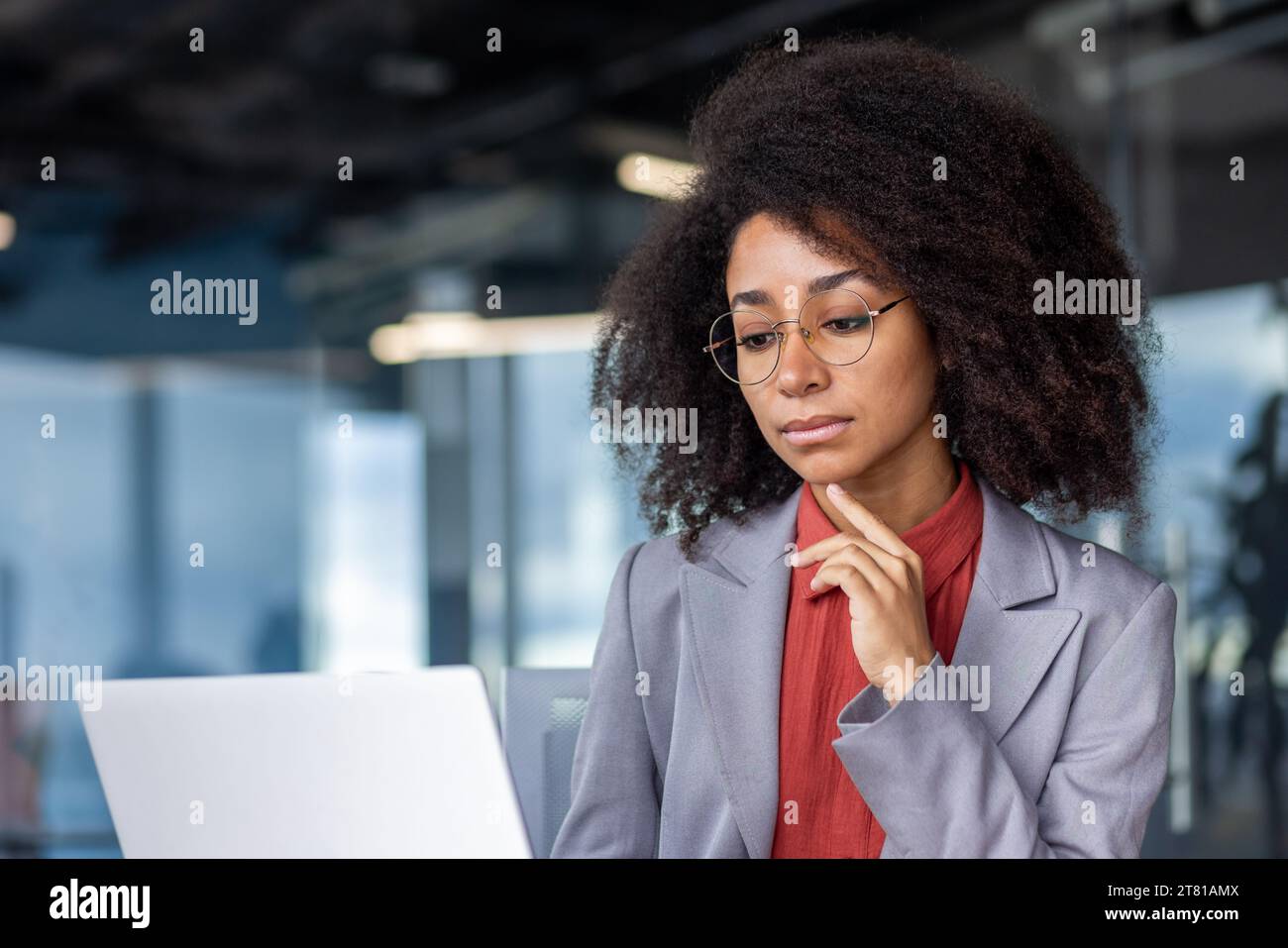 Serious focused and concentrated woman at workplace, thinking ...